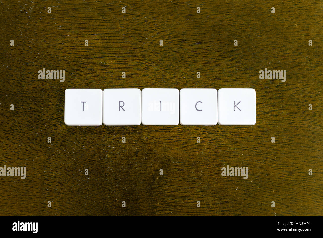 TRICK word written on plastic keyboard alphabet with dark background ...