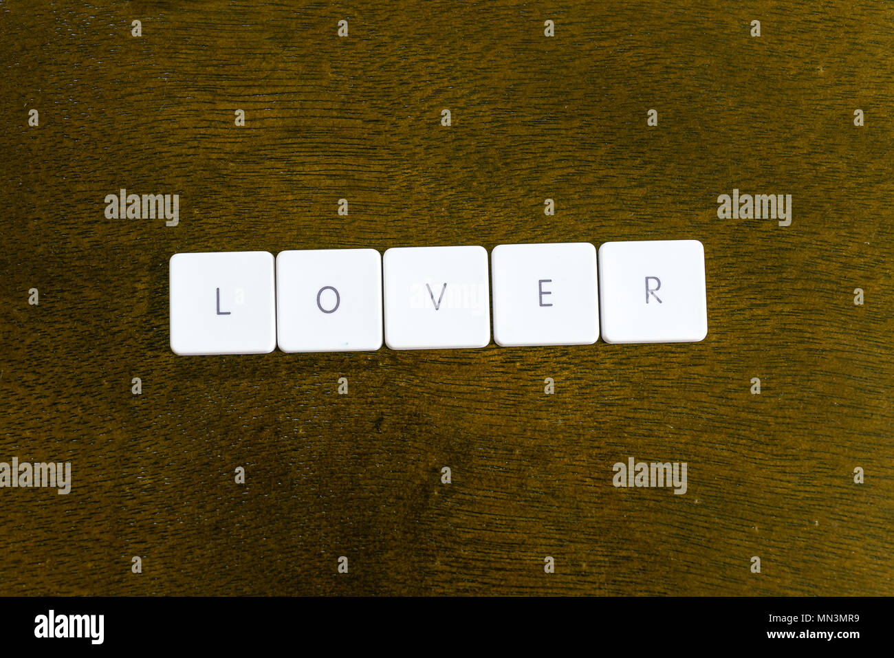 LOVER word written on plastic keyboard alphabet with dark background ...
