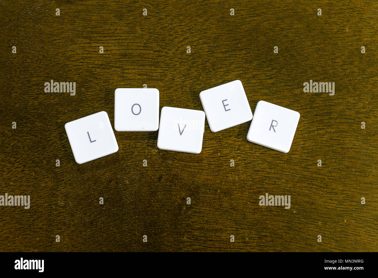 LOVER word written on plastic keyboard alphabet with dark background ...