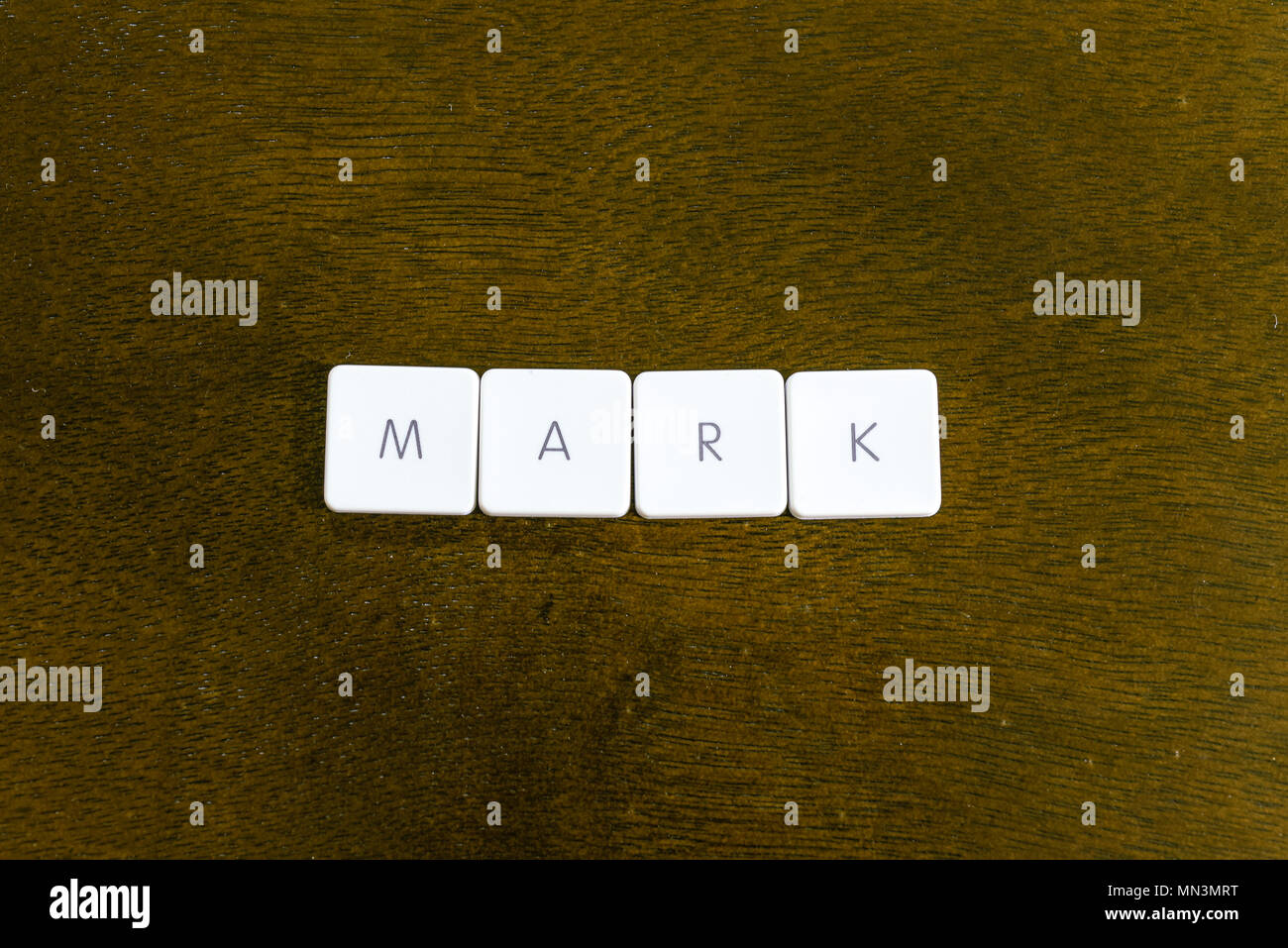 MARK word written on plastic keyboard alphabet with dark background ...