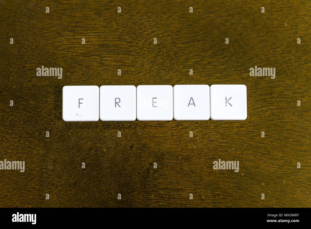 FREAK word written on plastic keyboard alphabet with dark background ...