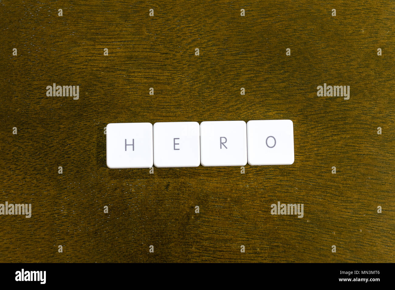 HERO word written on plastic keyboard alphabet with dark background ...