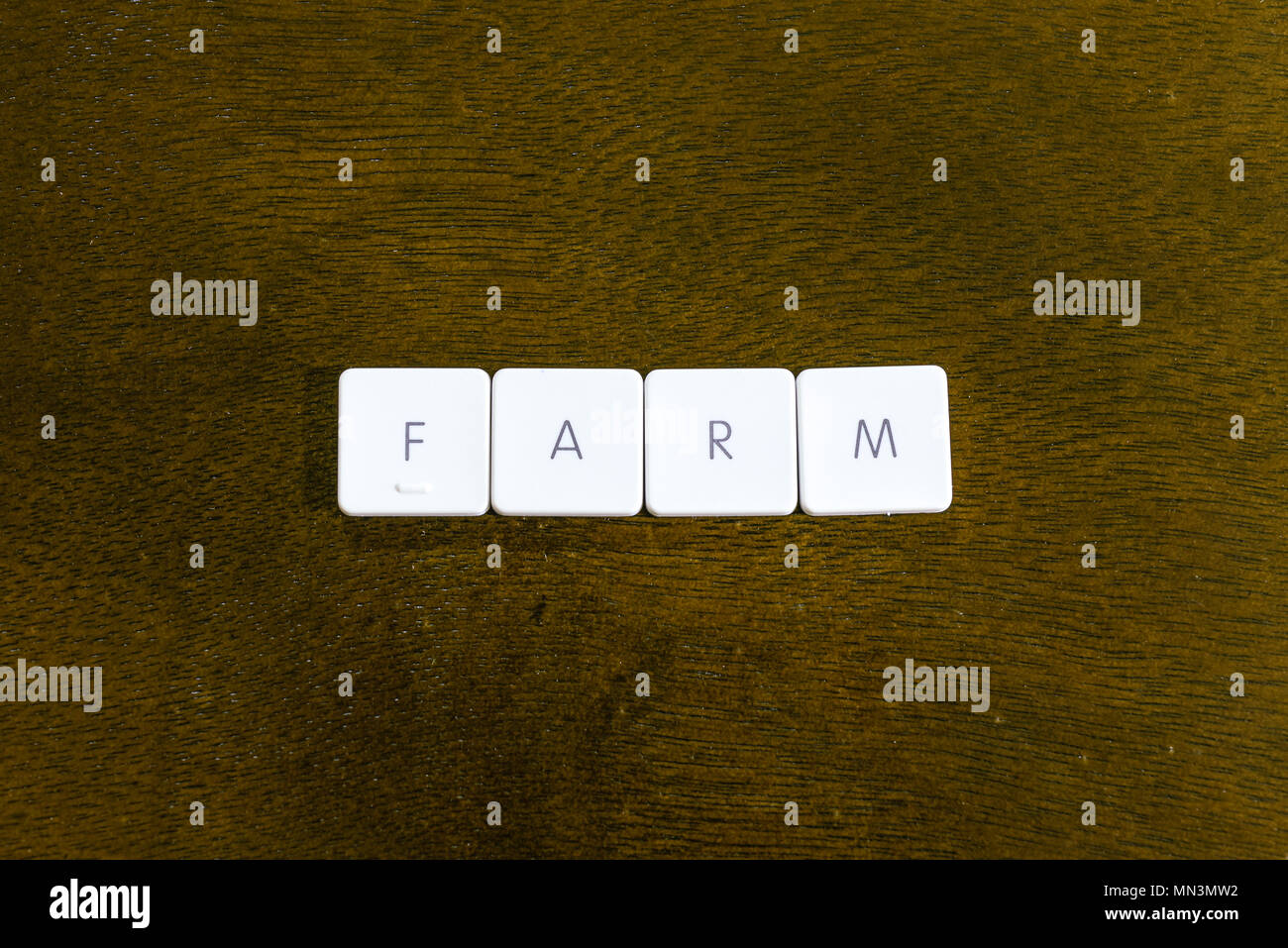 FARM word written on plastic keyboard alphabet with dark background ...