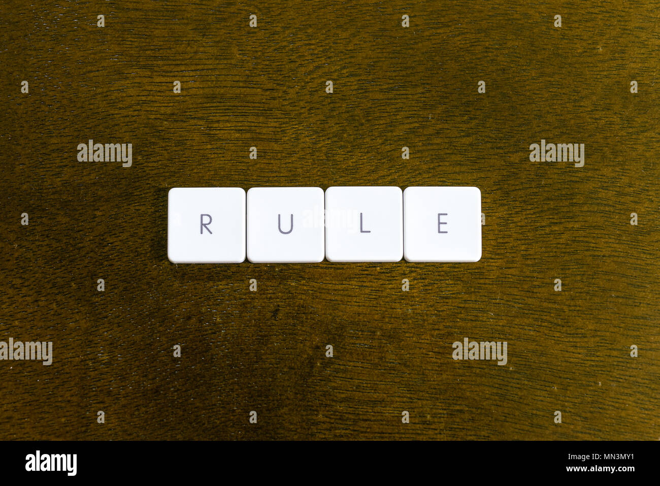 RULE word written on plastic keyboard alphabet with dark background ...