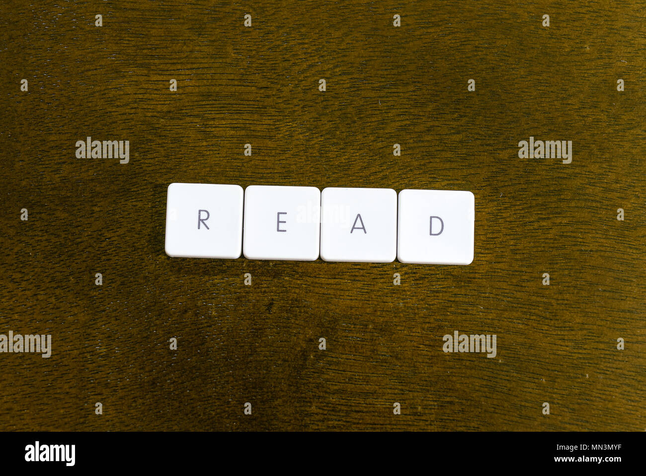 READ word written on plastic keyboard alphabet with dark background ...