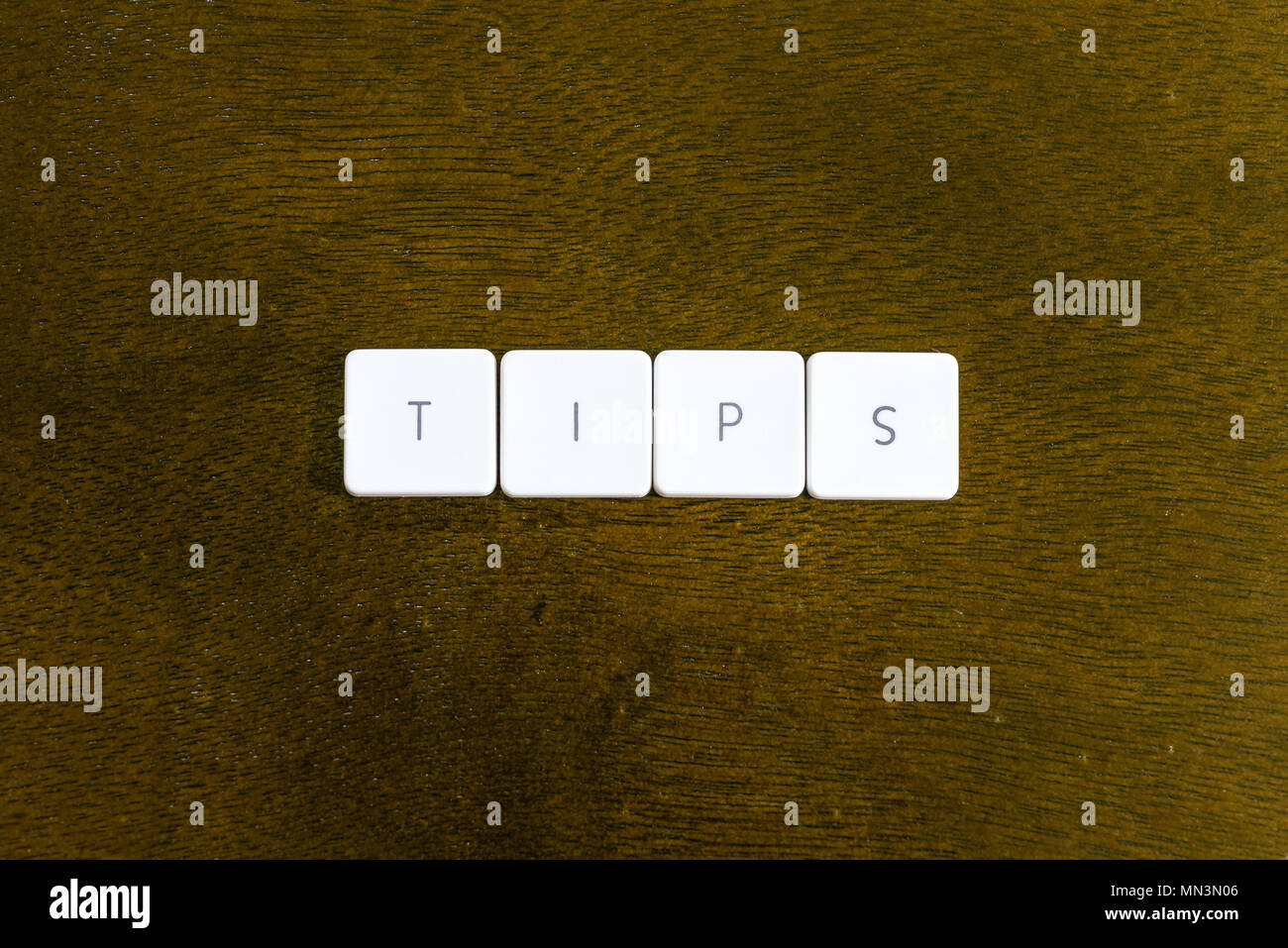 TIPS word written on plastic keyboard alphabet with dark background ...