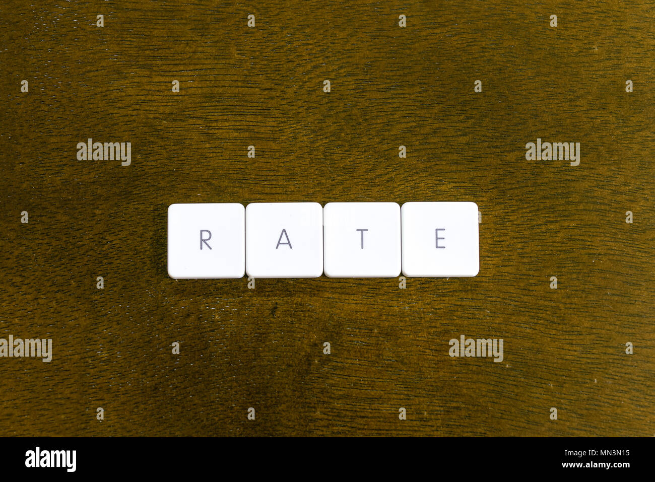 RATE word written on plastic keyboard alphabet with dark background ...