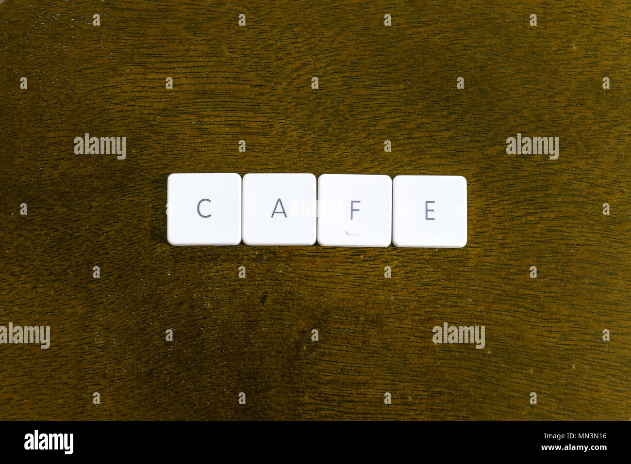 CAFE word written on plastic keyboard alphabet with dark background ...