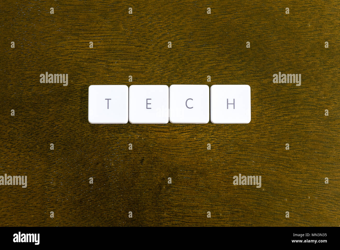 TECH word written on plastic keyboard alphabet with dark background ...