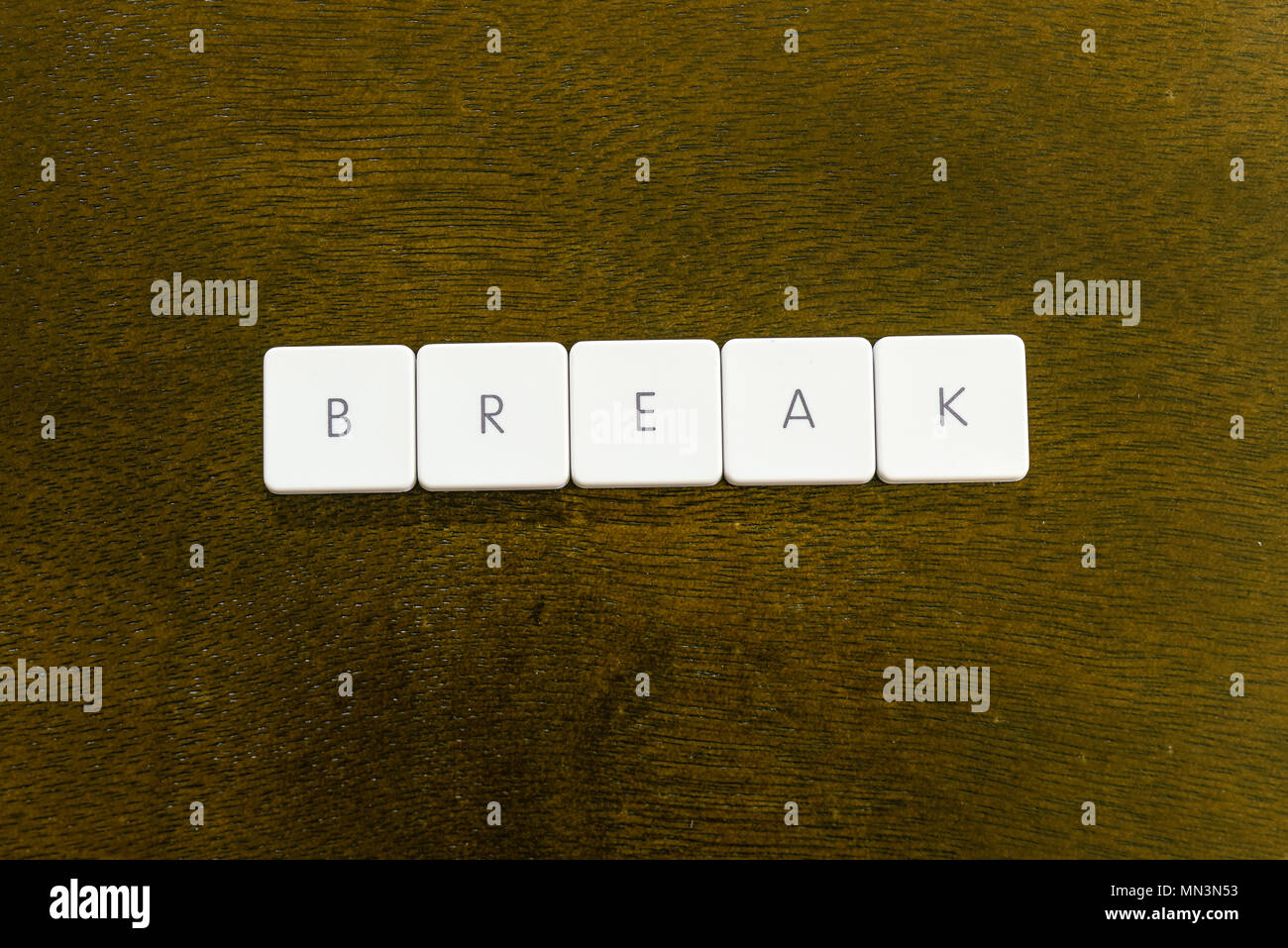 BREAK word written on plastic keyboard alphabet with dark background ...
