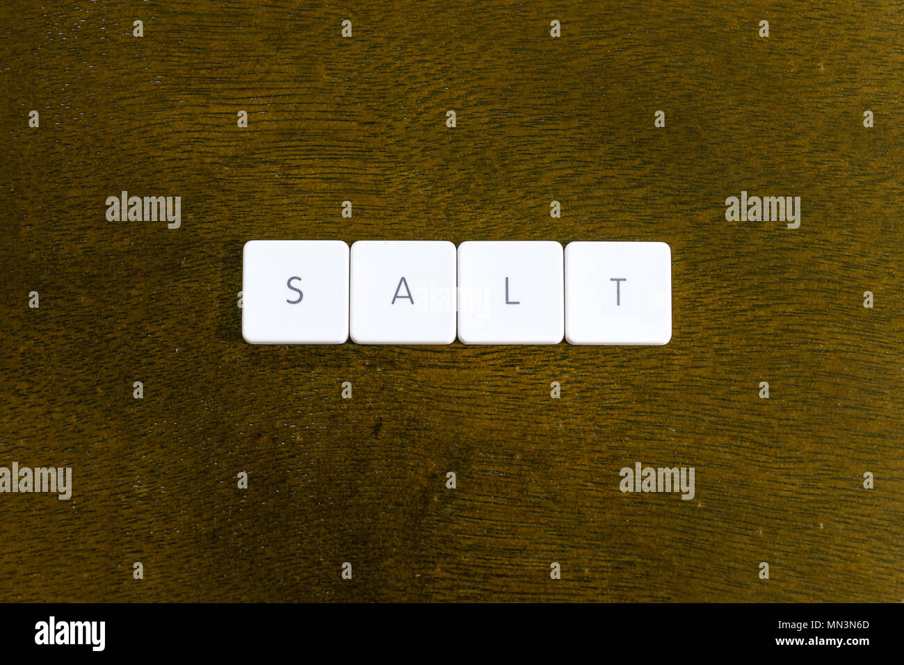 SALT word written on plastic keyboard alphabet with dark background ...