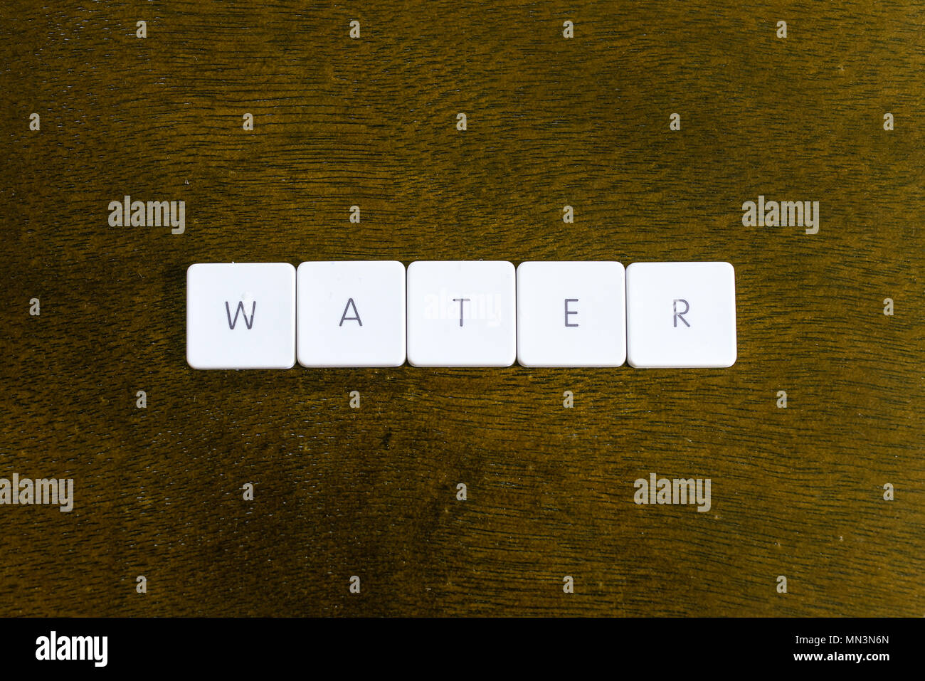 WATER word written on plastic keyboard alphabet with dark background ...