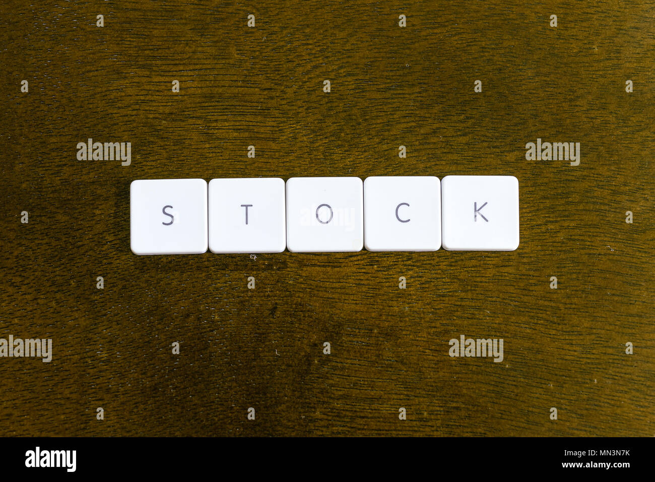 STOCK word written on plastic keyboard alphabet with dark background ...