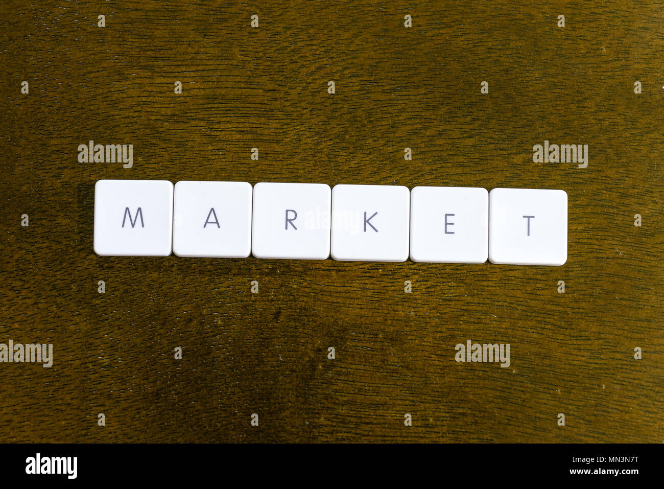 MARKET word written on plastic keyboard alphabet with dark background ...