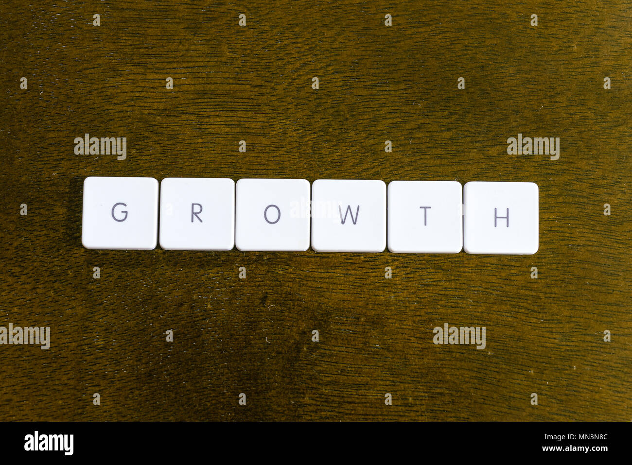 GROWTH word written on plastic keyboard alphabet with dark background ...