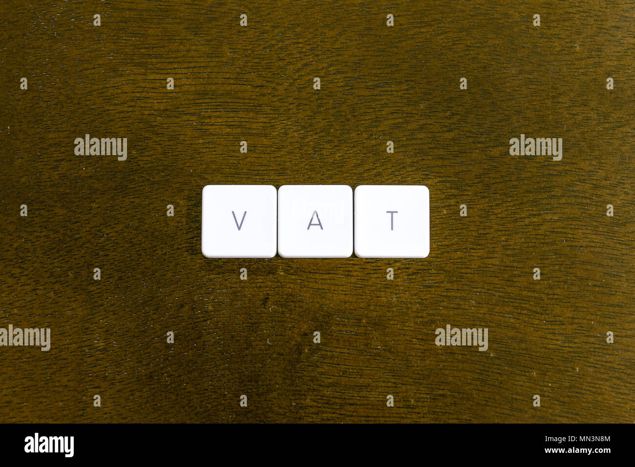 VAT word written on plastic keyboard alphabet with dark background ...