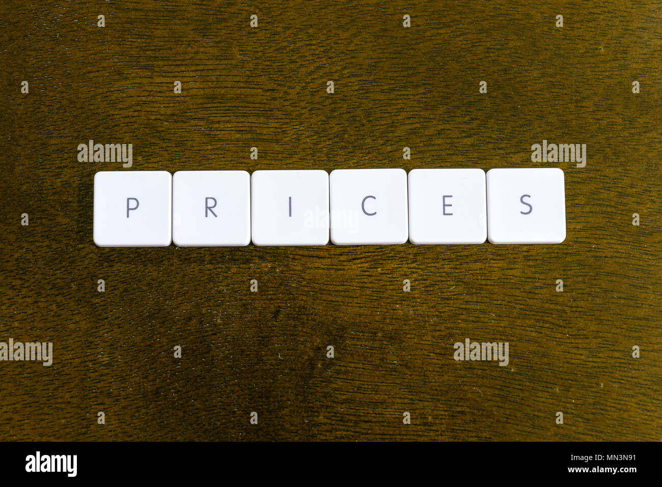 PRICES word written on plastic keyboard alphabet with dark background ...