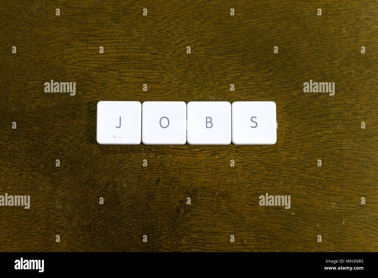 JOBS word written on plastic keyboard alphabet with dark background ...