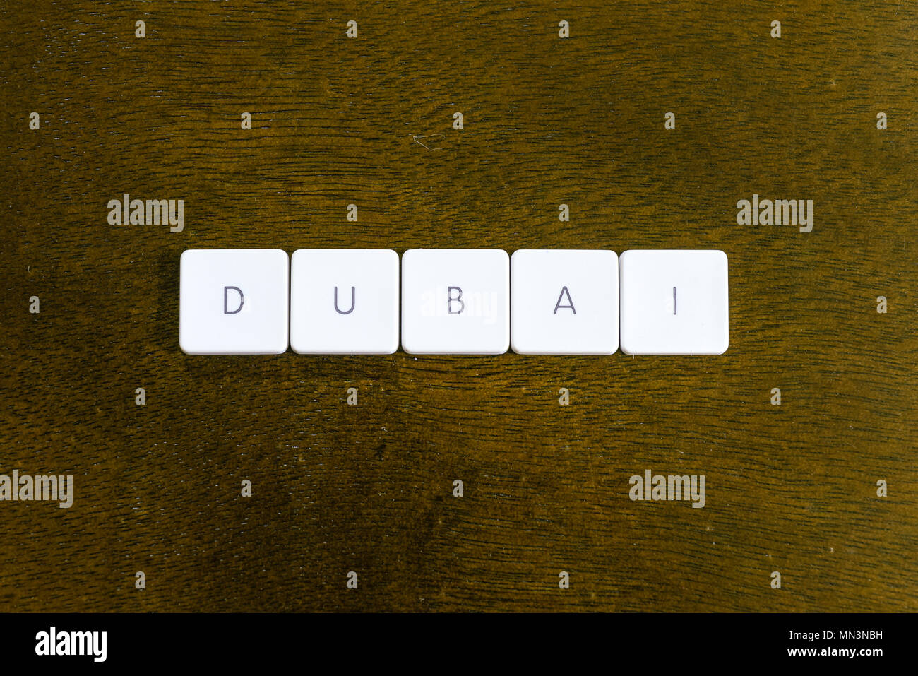 DUBAI word written on plastic keyboard alphabet with dark background ...