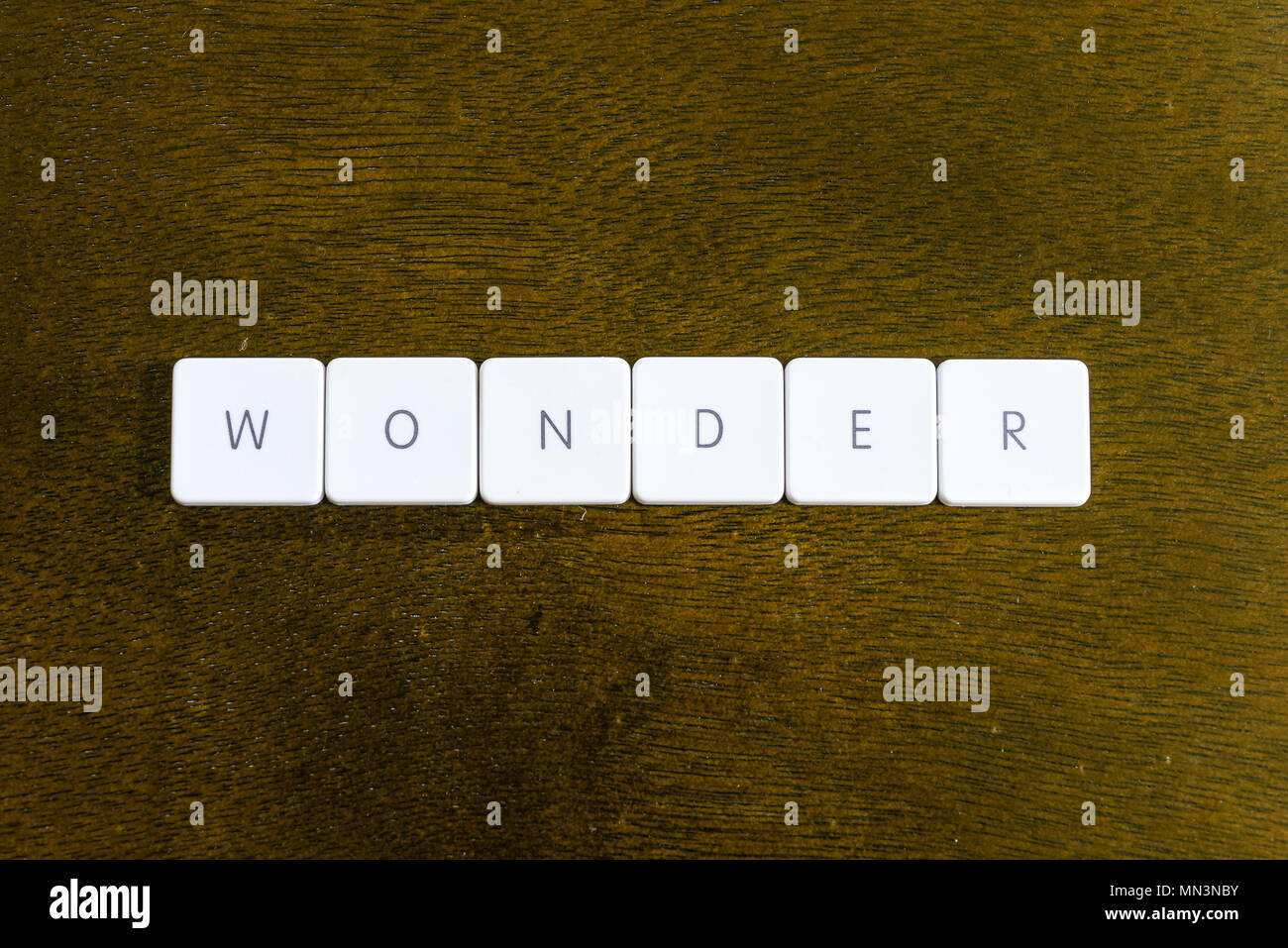 WONDER word written on plastic keyboard alphabet with dark background ...
