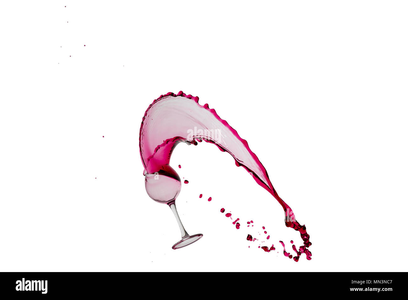 Falling wine glass with splashes of red wine on white isolated ...