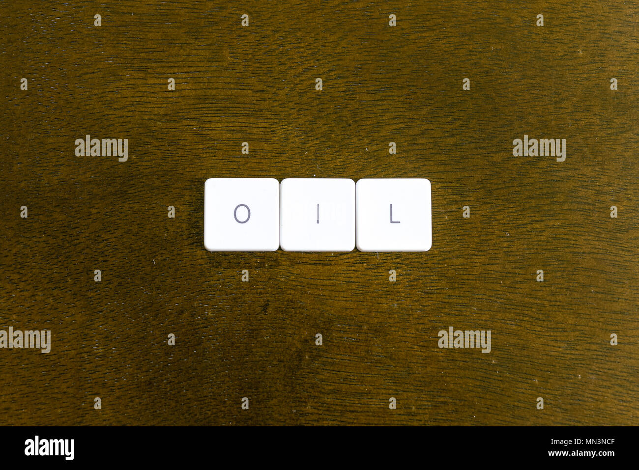 OIL word written on plastic keyboard alphabet with dark background ...