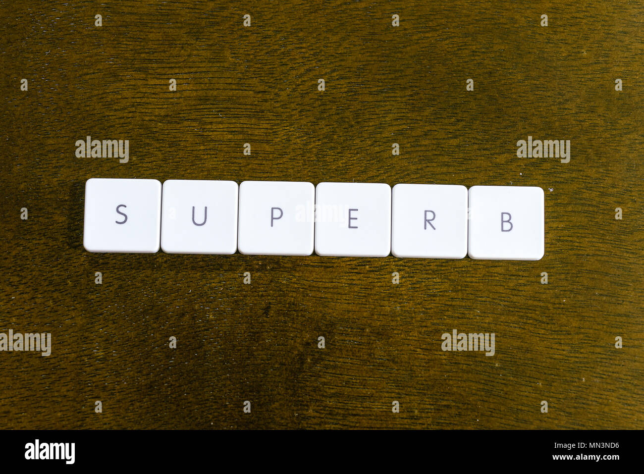 SUPERB word written on plastic keyboard alphabet with dark background ...