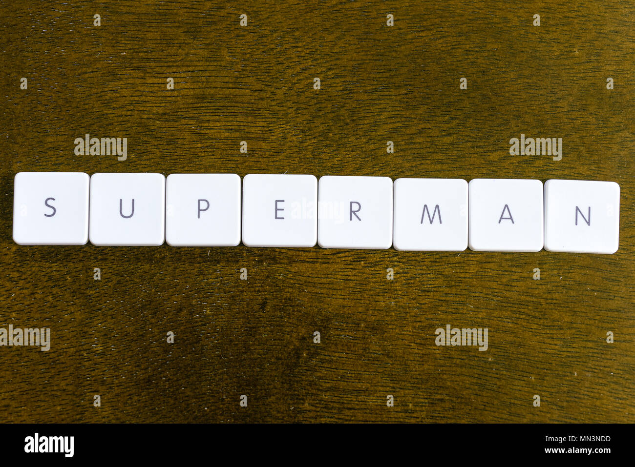 SUPERMAN word written on plastic keyboard alphabet with dark background ...