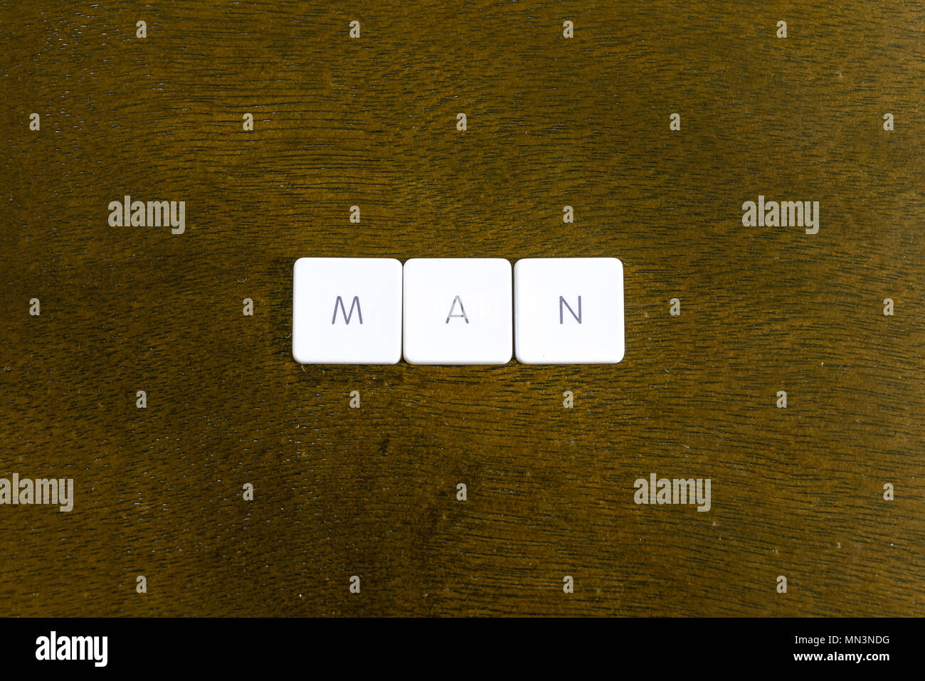 MAN word written on plastic keyboard alphabet with dark background ...