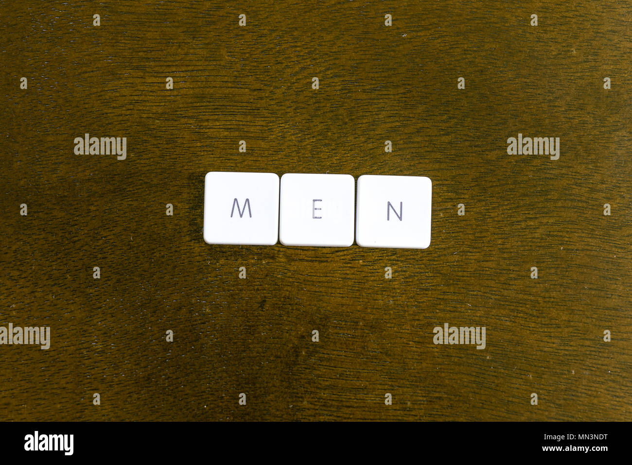 MEN word written on plastic keyboard alphabet with dark background ...