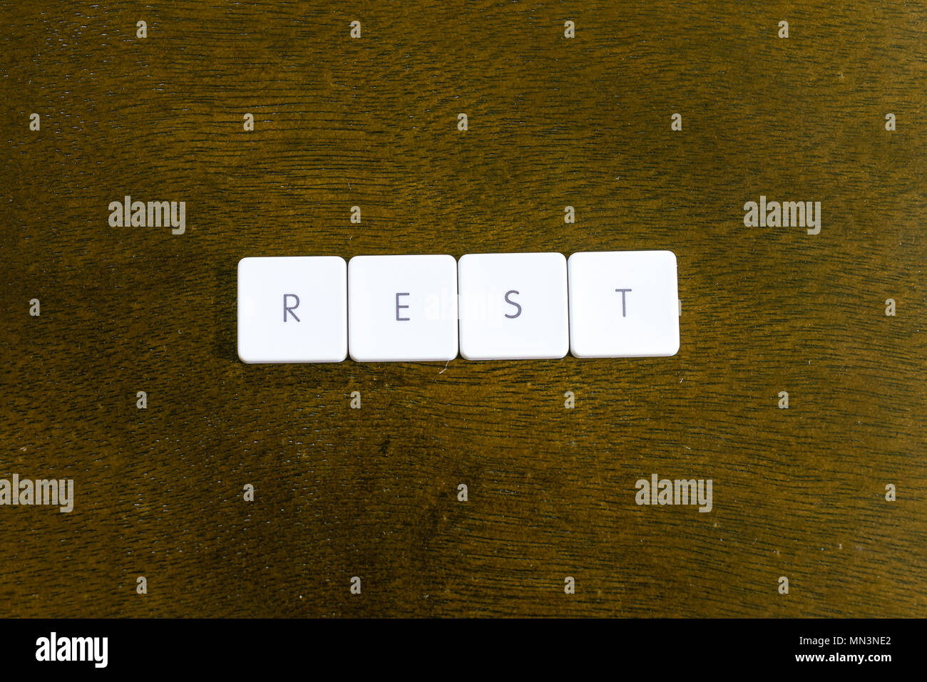 REST word written on plastic keyboard alphabet with dark background ...