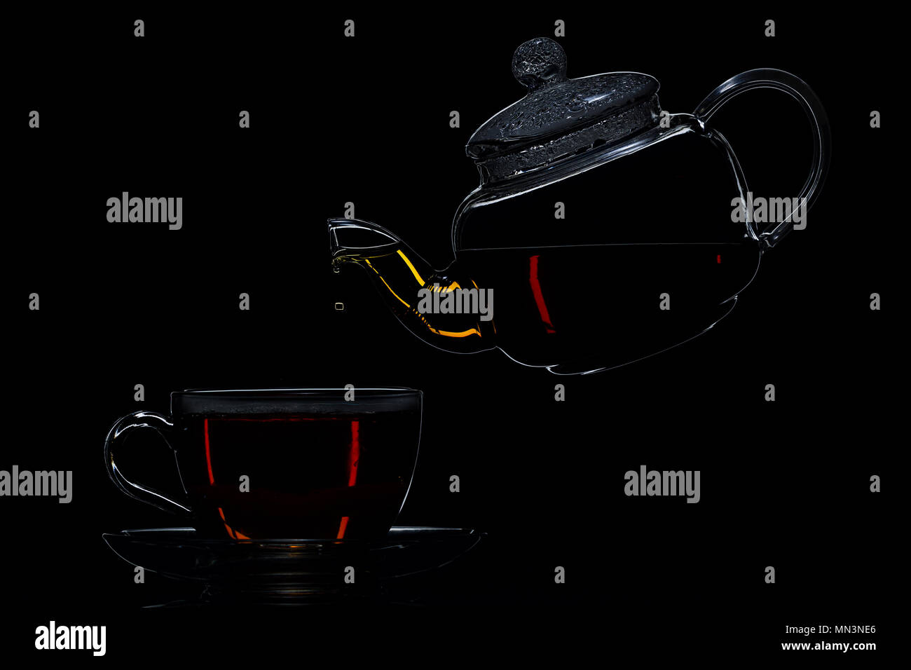 Tea in a transparent teapot on a black background, studio light Stock ...