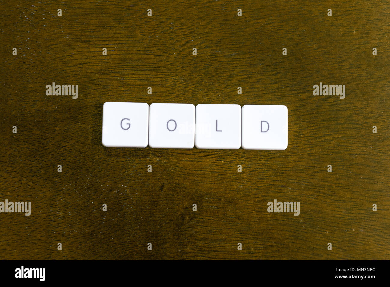 GOLD word written on plastic keyboard alphabet with dark background ...