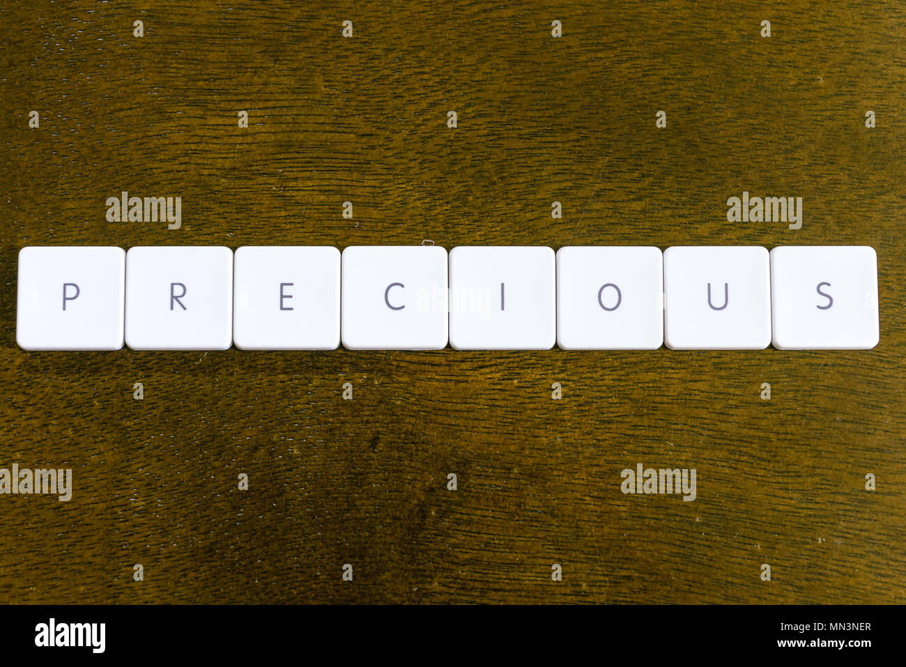 PRECIOUS word written on plastic keyboard alphabet with dark background ...