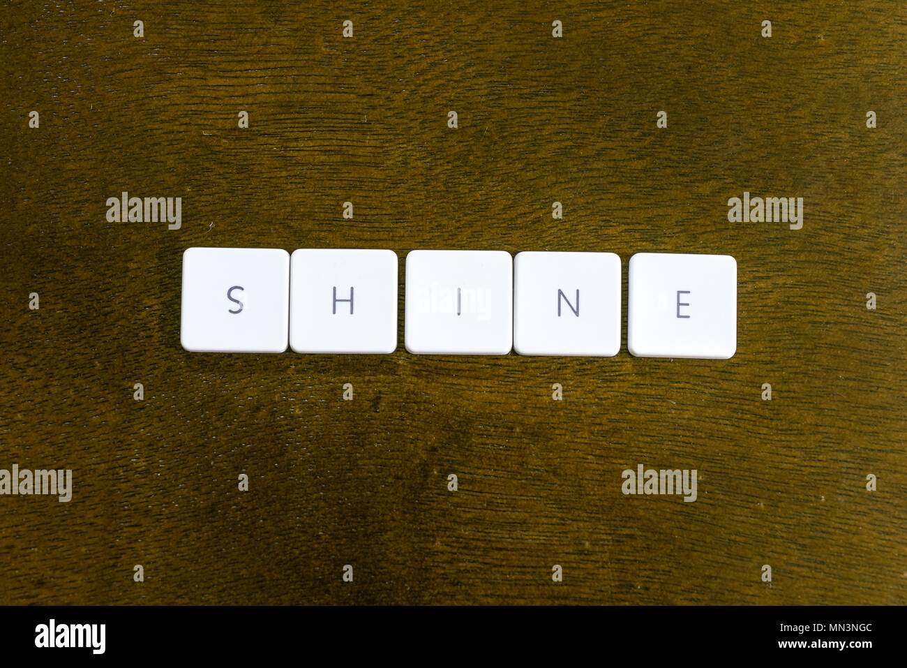 SHINE word written on plastic keyboard alphabet with dark background ...