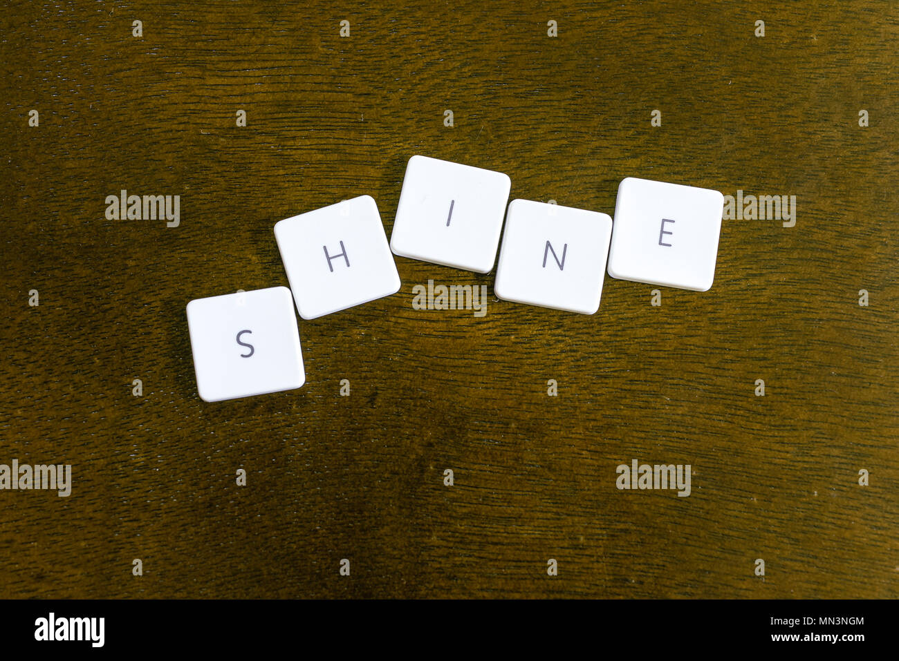 SHINE word written on plastic keyboard alphabet with dark background ...