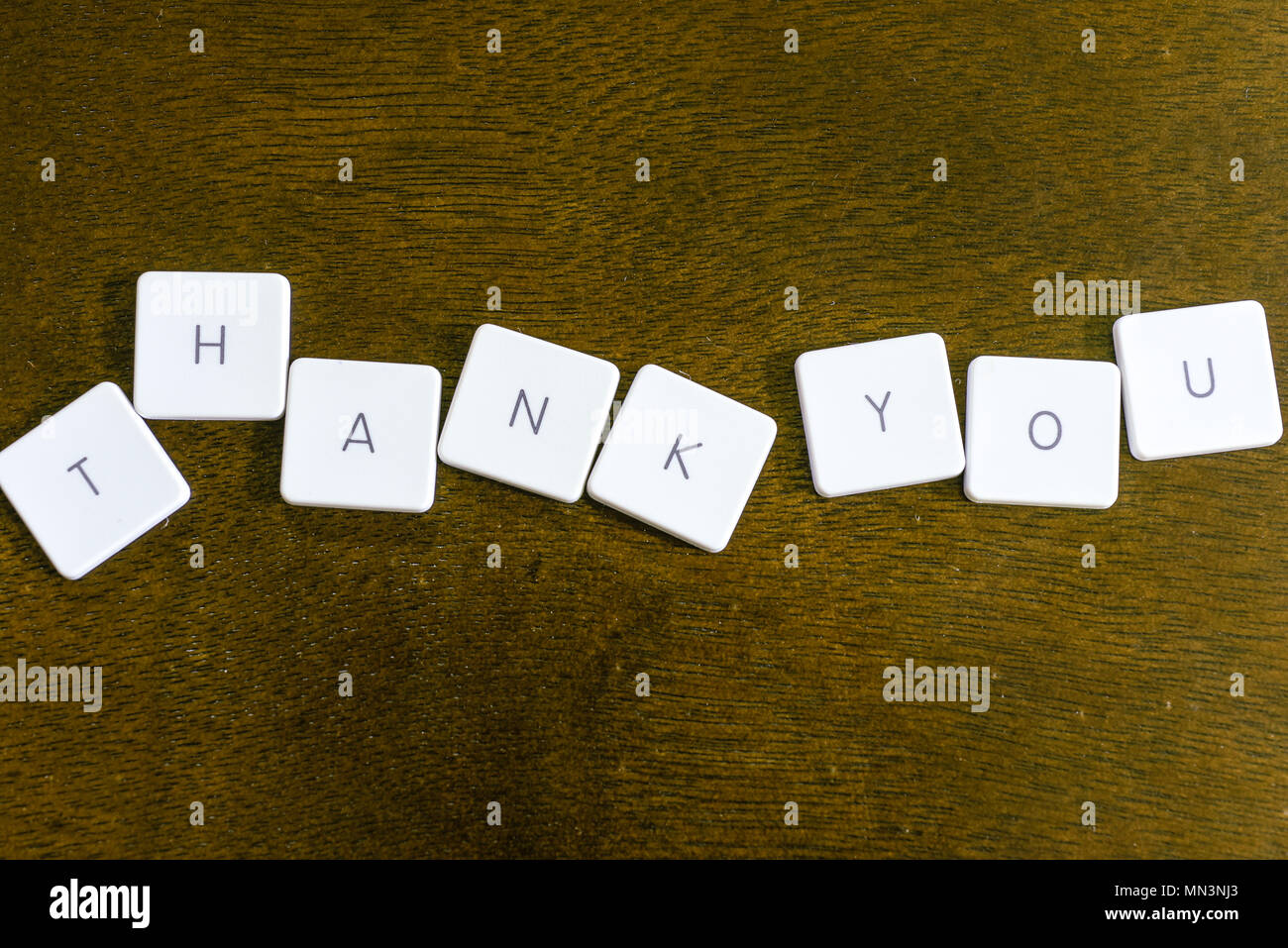 THANK YOU word written on plastic keyboard alphabet with dark ...