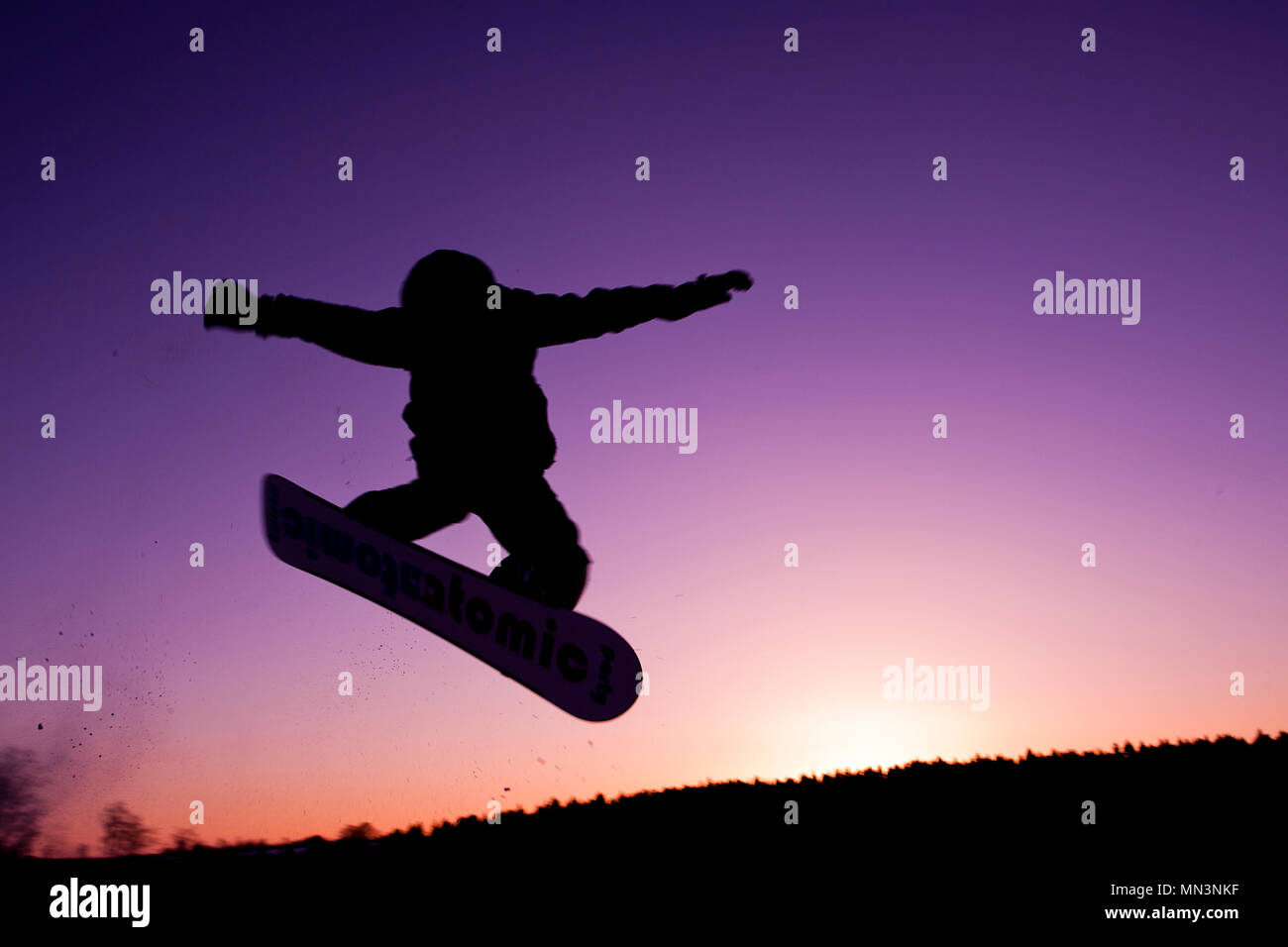Silhouette snowboarder flying at sunset sky background. Soft focus ...