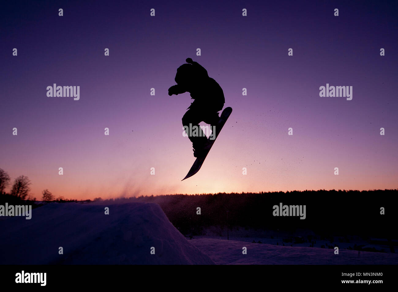 Silhouette snowboarder flying at sunset sky background. Soft focus ...