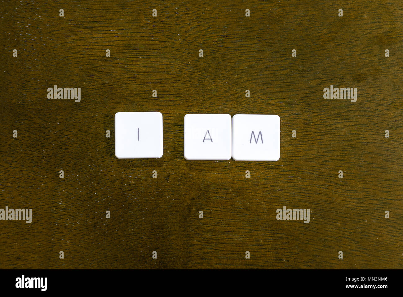 I AM word written on plastic keyboard alphabet with dark background ...
