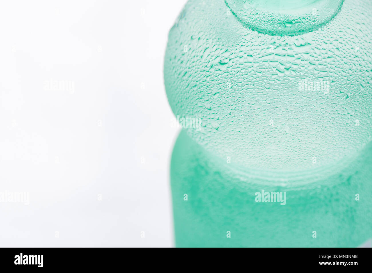 Light Green Sweated Frosty Bottle with Clear Pure Cool Water on White ...