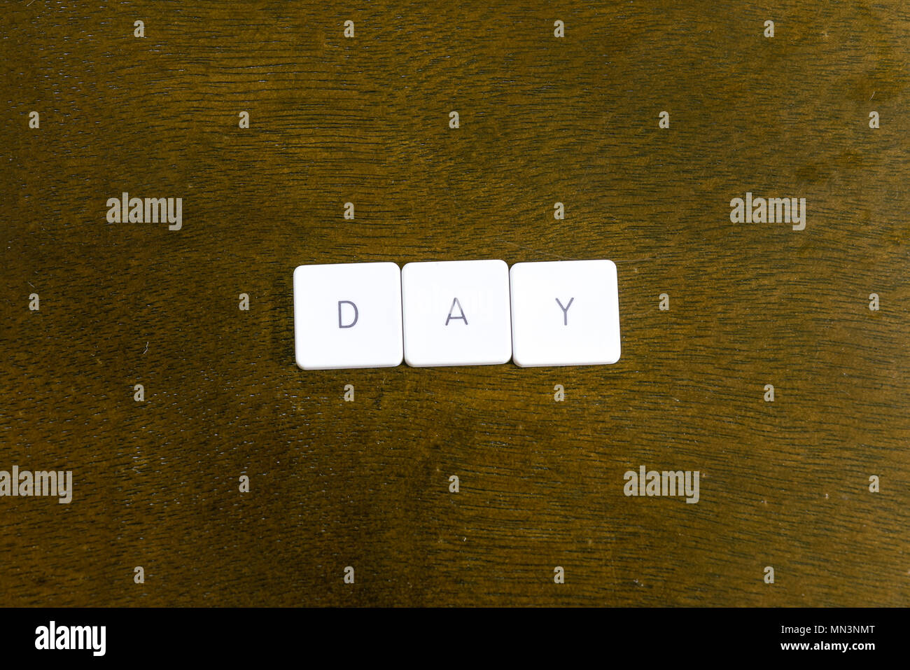 DAY word written on plastic keyboard alphabet with dark background ...