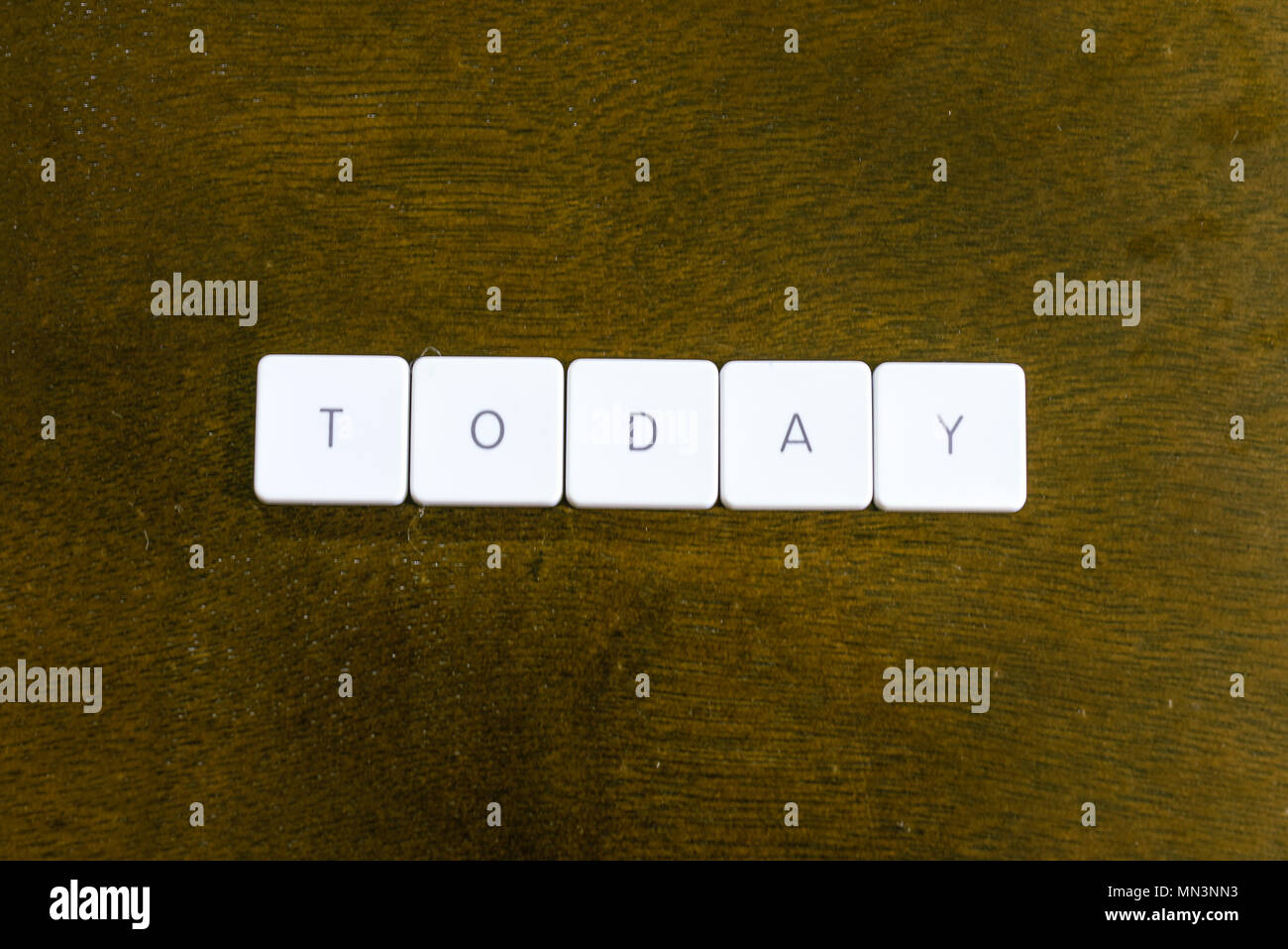 TODAY word written on plastic keyboard alphabet with dark background ...