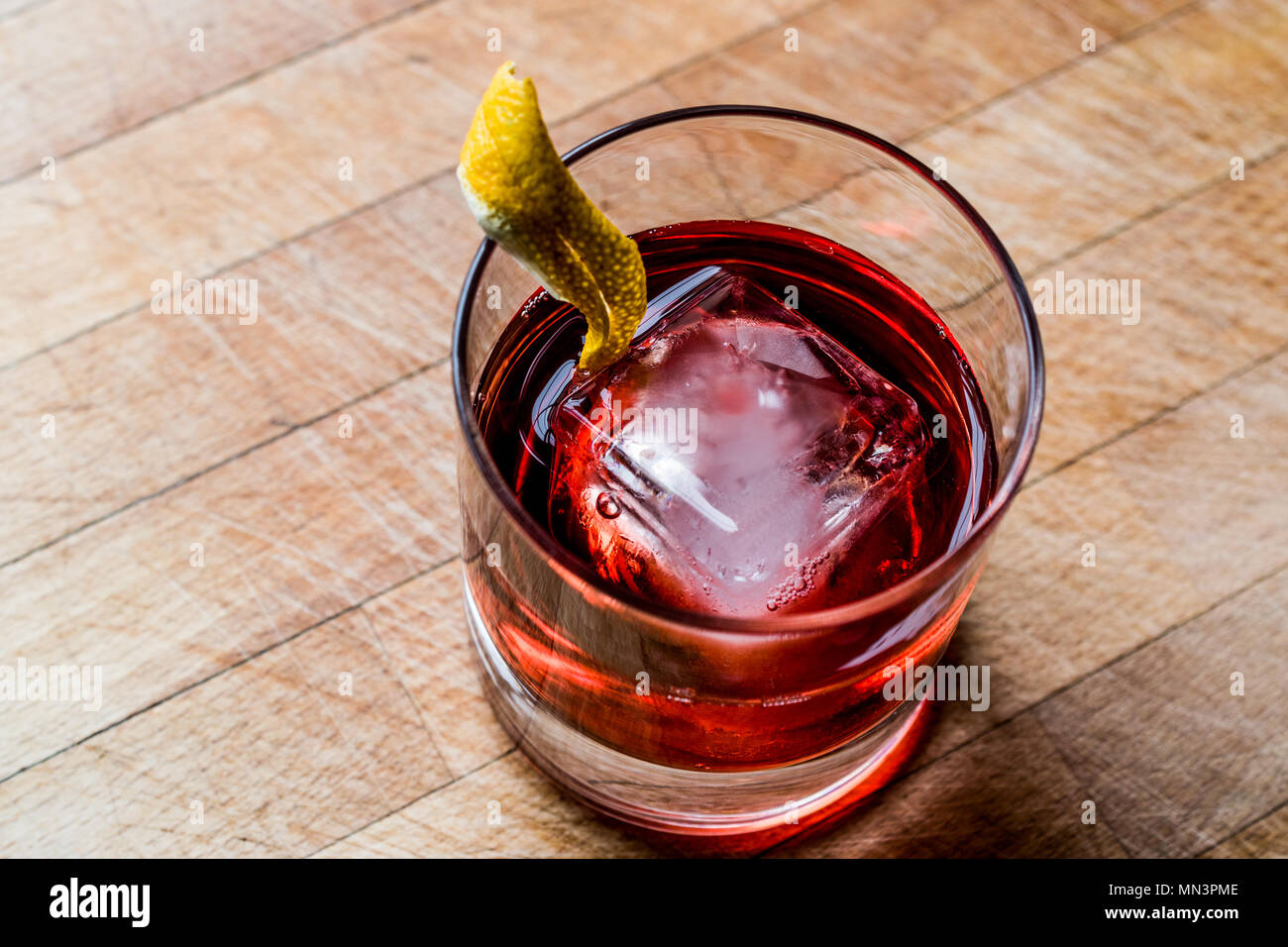 Negroni Cocktail with lemon peel and ice. Beverage Concept Stock Photo ...
