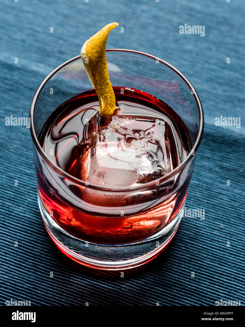 Negroni Cocktail with lemon peel and ice. Beverage Concept Stock Photo ...