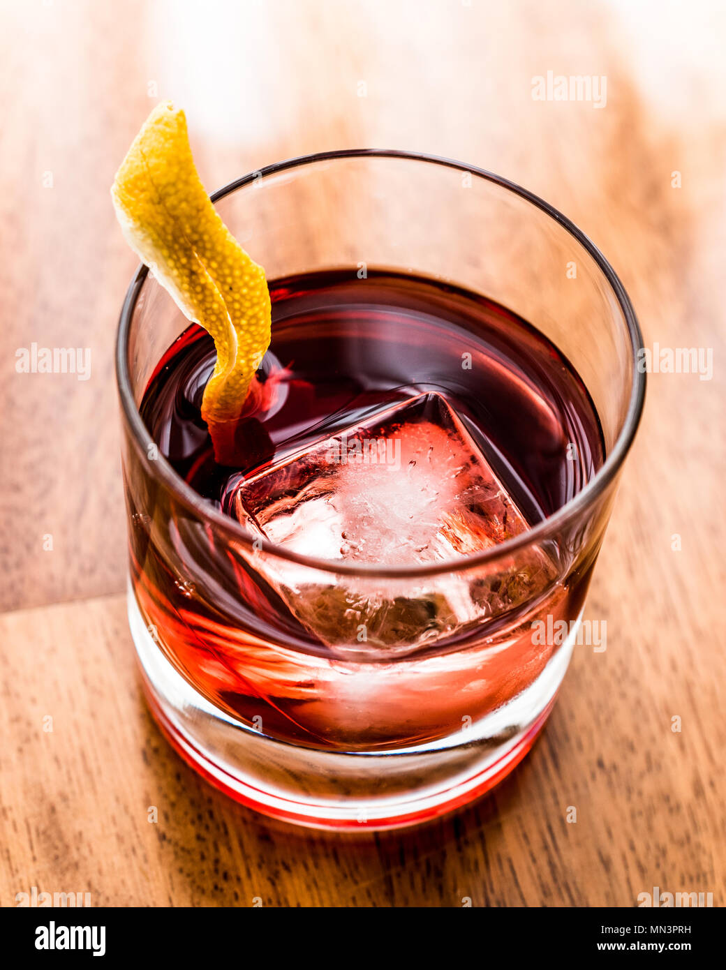 Negroni Cocktail with lemon peel and ice. Beverage Concept Stock Photo ...