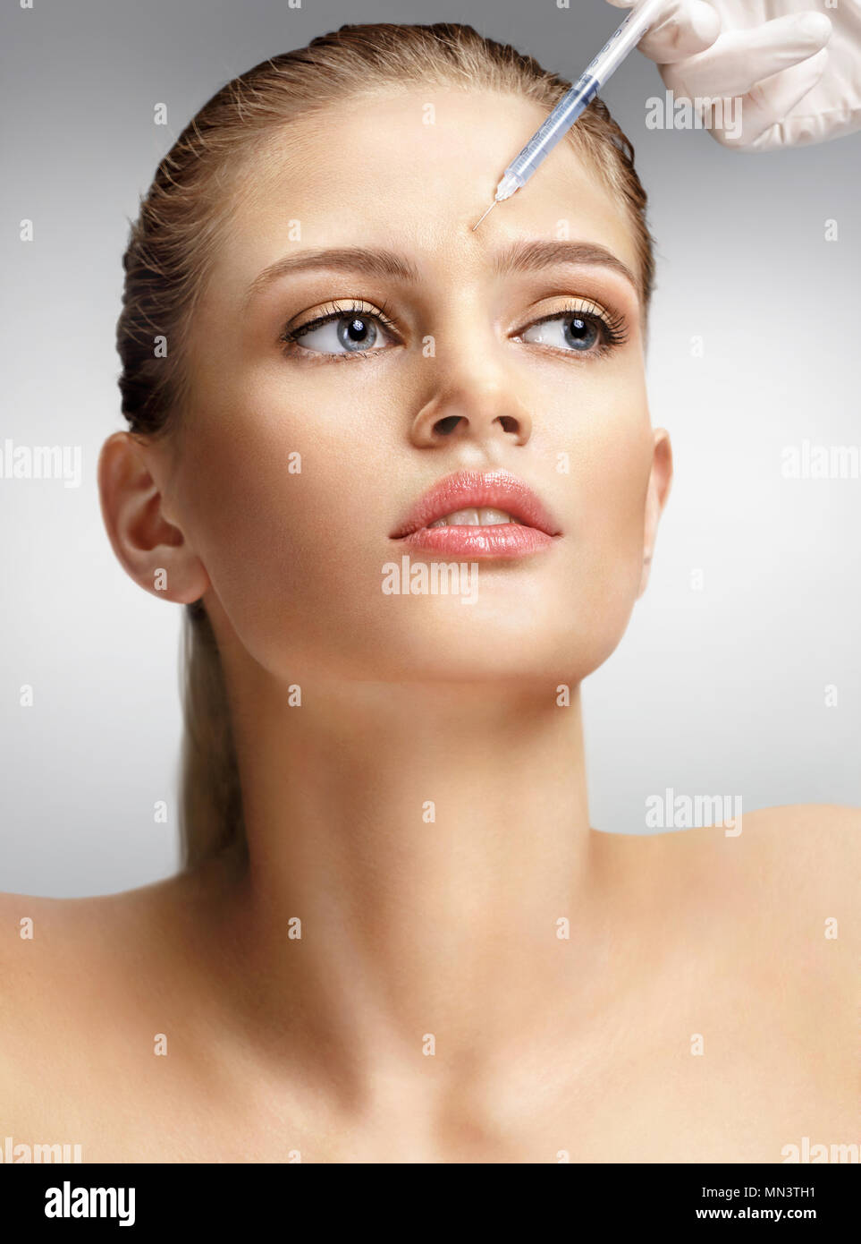 Beautiful woman face and beautician hands with syringe makes cosmetic ...