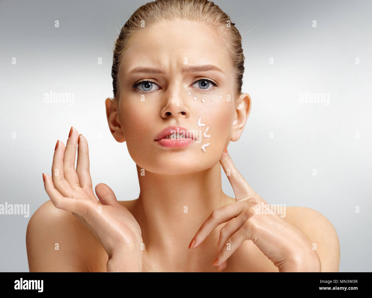 Upset woman touching her face. Photo of attractive woman with anti ...