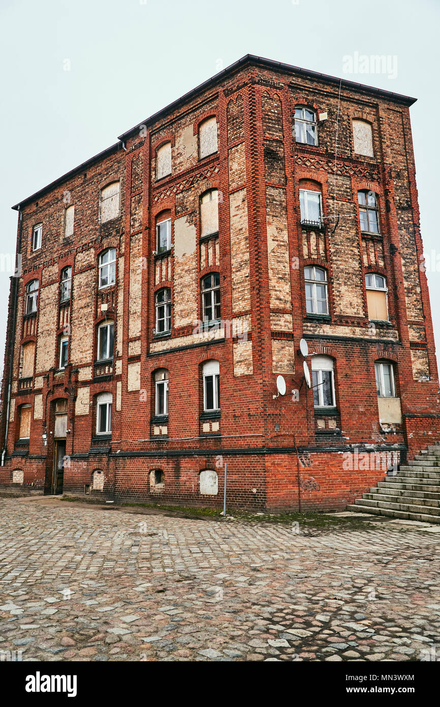 The facade of the destroyed red-brick building in Poznan Stock Photo ...