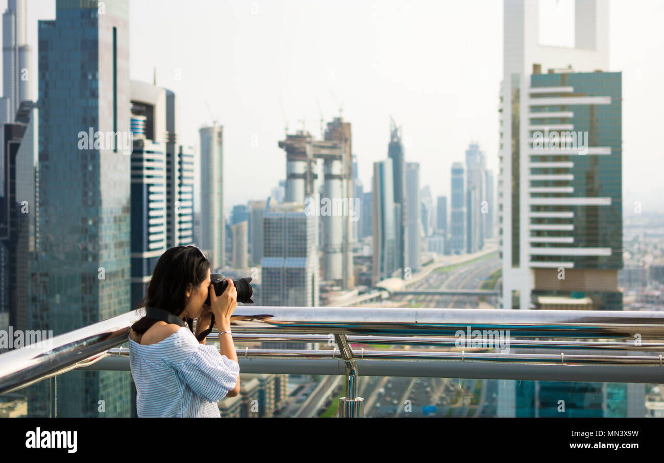 Female photographer taking picture of Dubai cityscape Stock Photo - Alamy